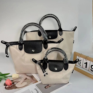 龙骧包energy饺子包男女通用斜挎包英文打孔手提单肩百搭通勤包潮-阿里巴巴